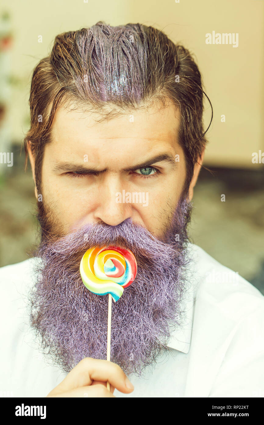 bearded man with blue beard and lollipop Stock Photo - Alamy