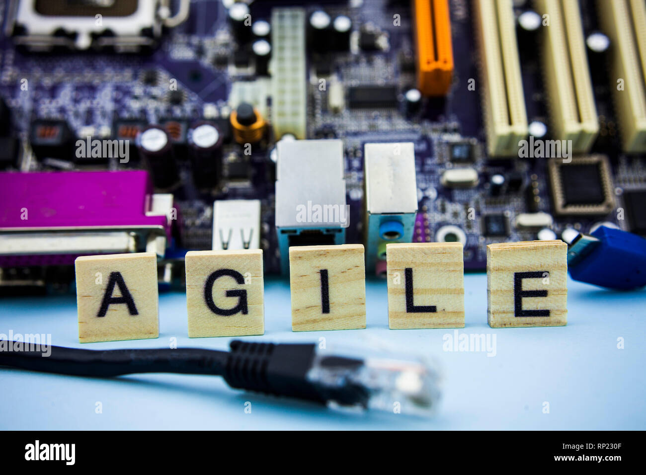 Word AGILE on the wooden blocks with computer technology mainboard ...