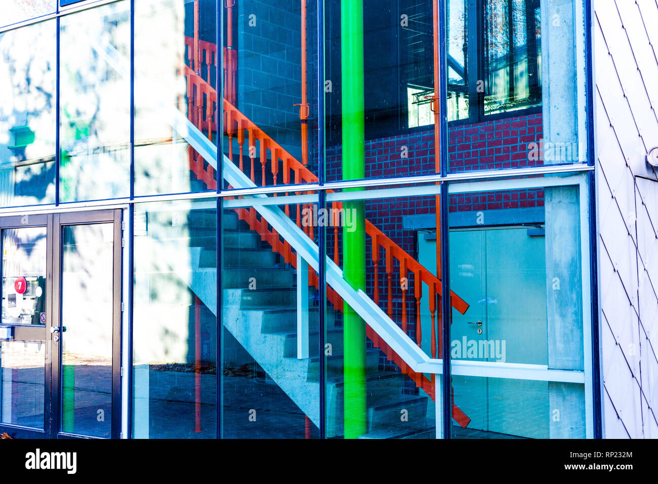 Concrete stairs in the building. Stairs behind the glass. Entrance to ...
