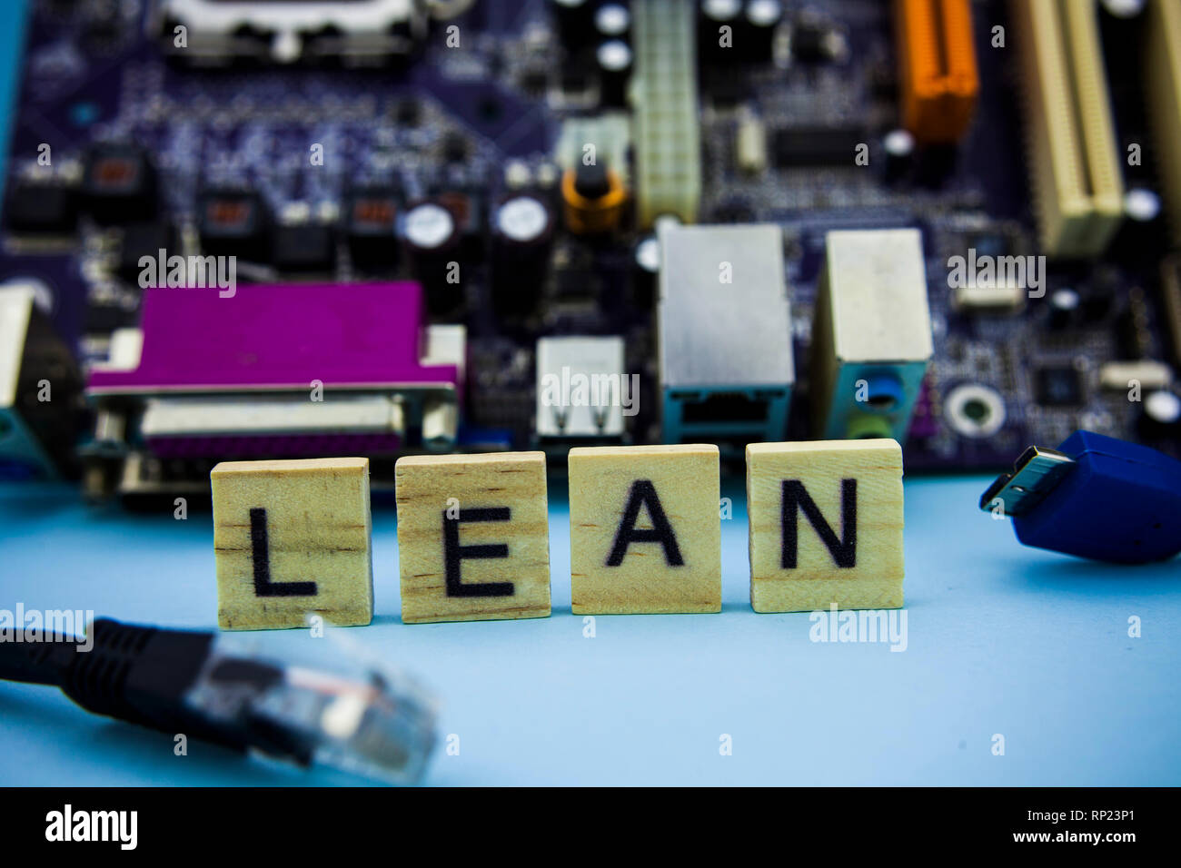 Word LEAN on the wooden blocks with computer mainboard in the ...