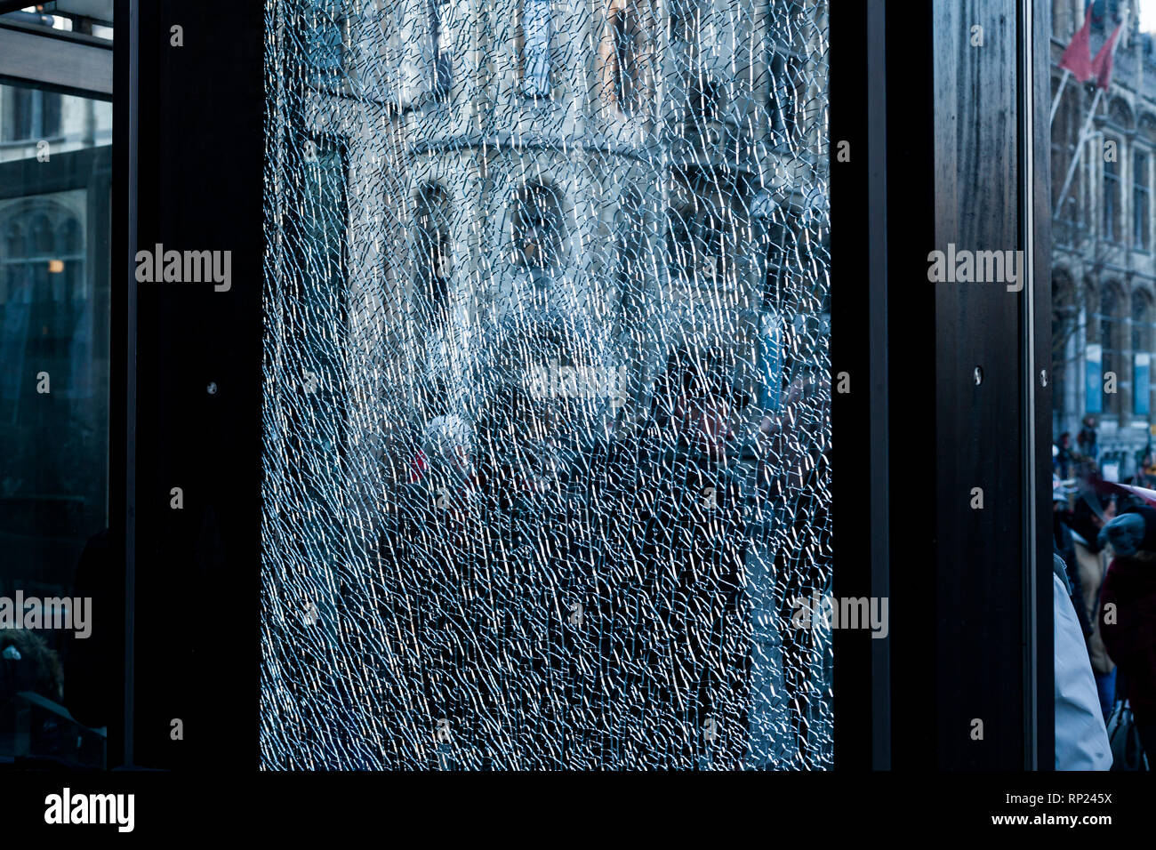 Abstract view through the window with blurred glass. Crowd of people ...