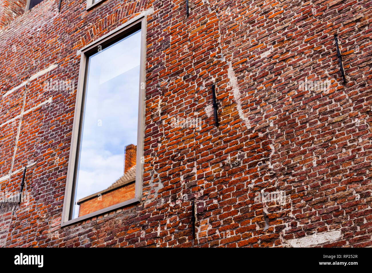 Window on the old red brick building. Old retro house made of the red ...