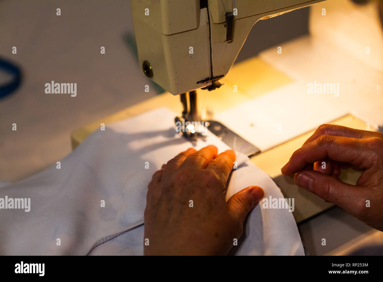 Women's hands on the sewing machine. Industry concept with creating ...