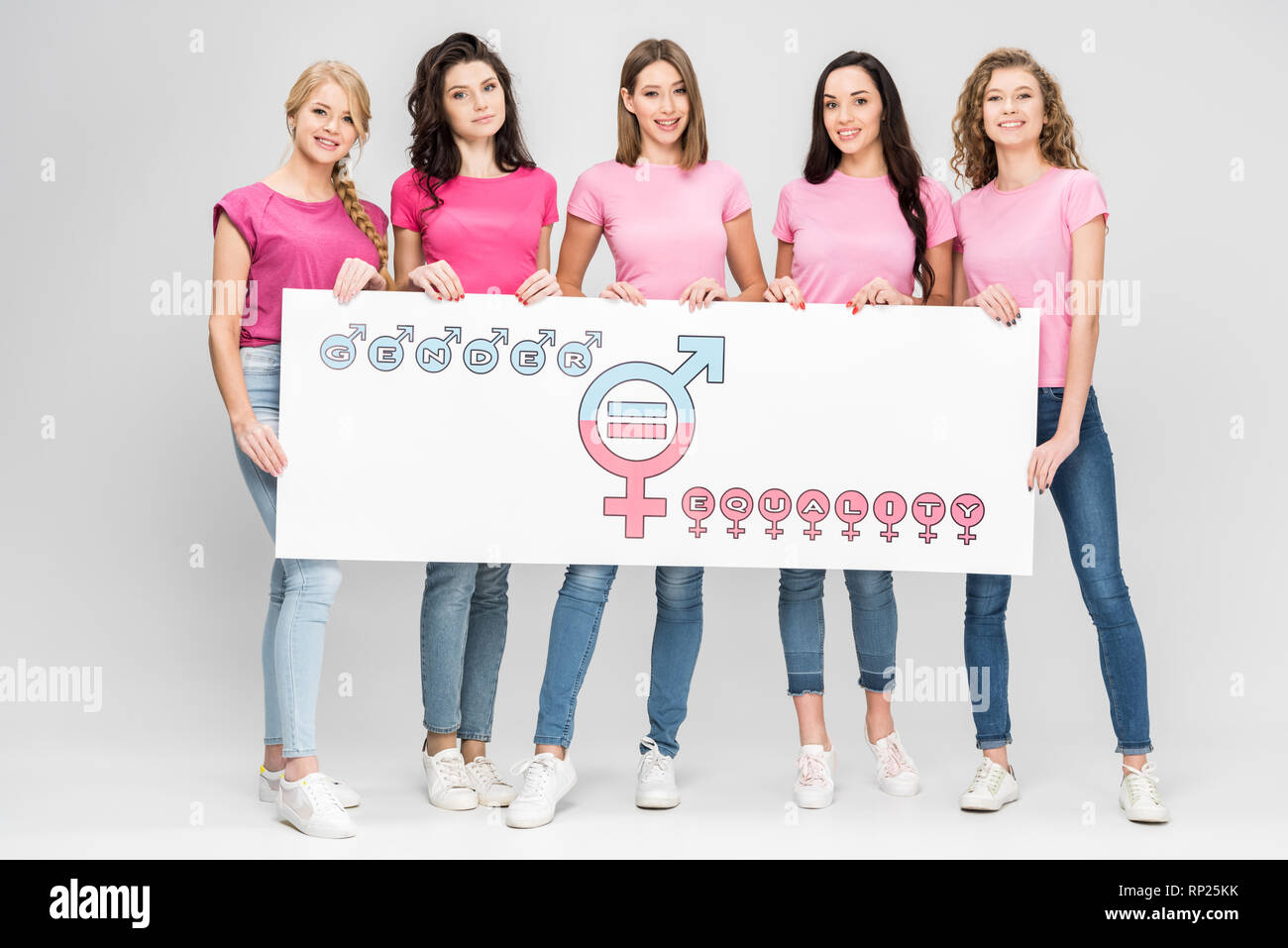 attractive young women holding large sign with gender equality symbol ...