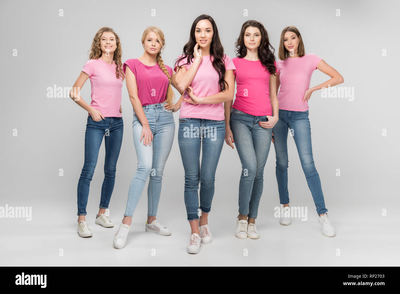 beautiful strong women standing together on grey background Stock Photo ...