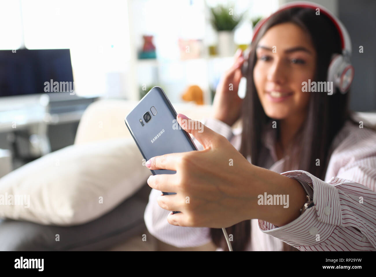 Young beautiful woman look camera holds Stock Photo - Alamy