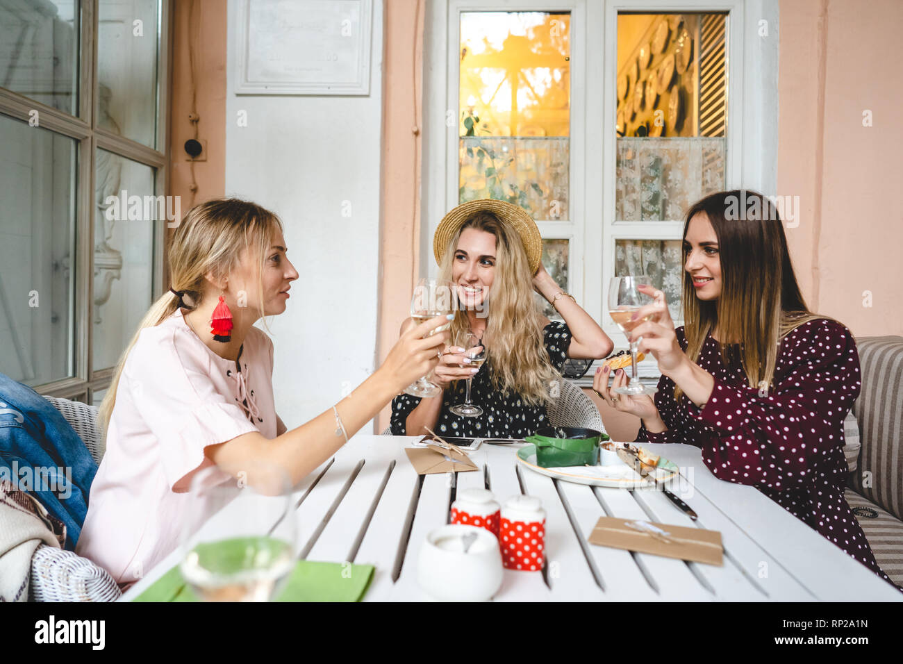 Three girls at the table Stock Photo - Alamy