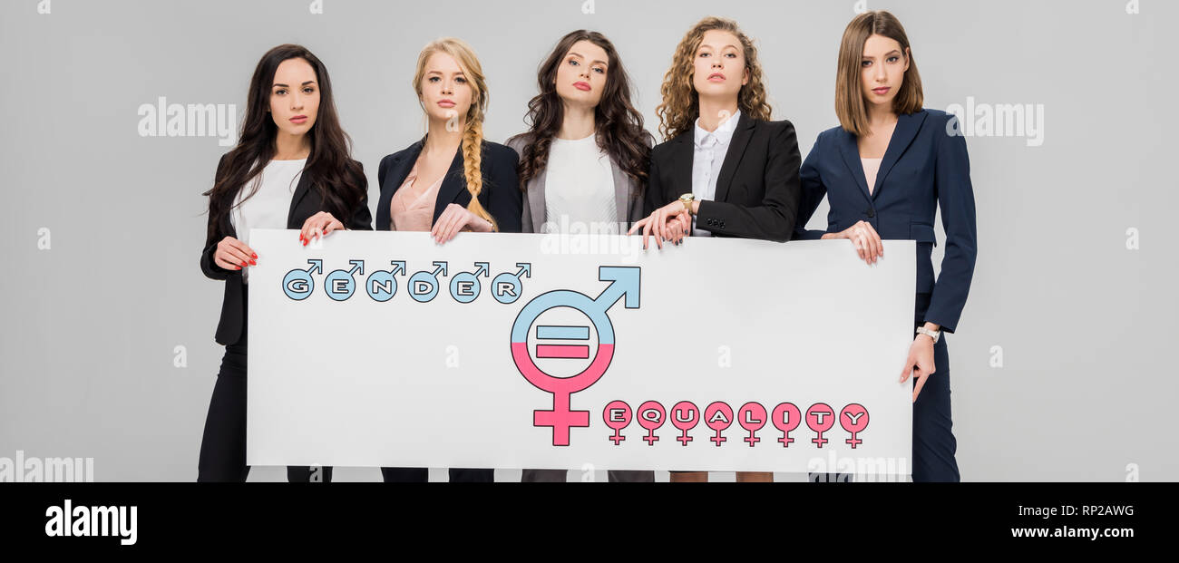 successful young women holding large sign with gender equality symbol ...