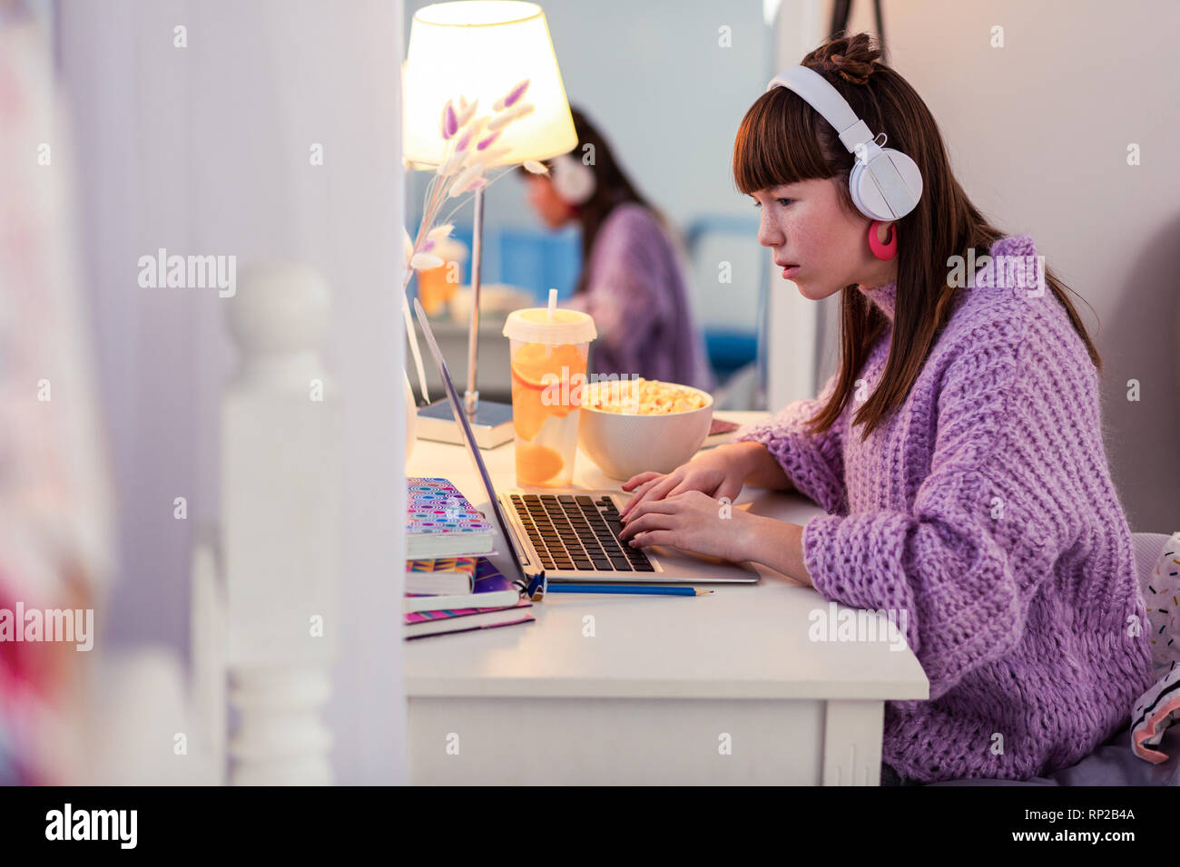 Attentive schoolgirl staring at screen of her laptop Stock Photo - Alamy