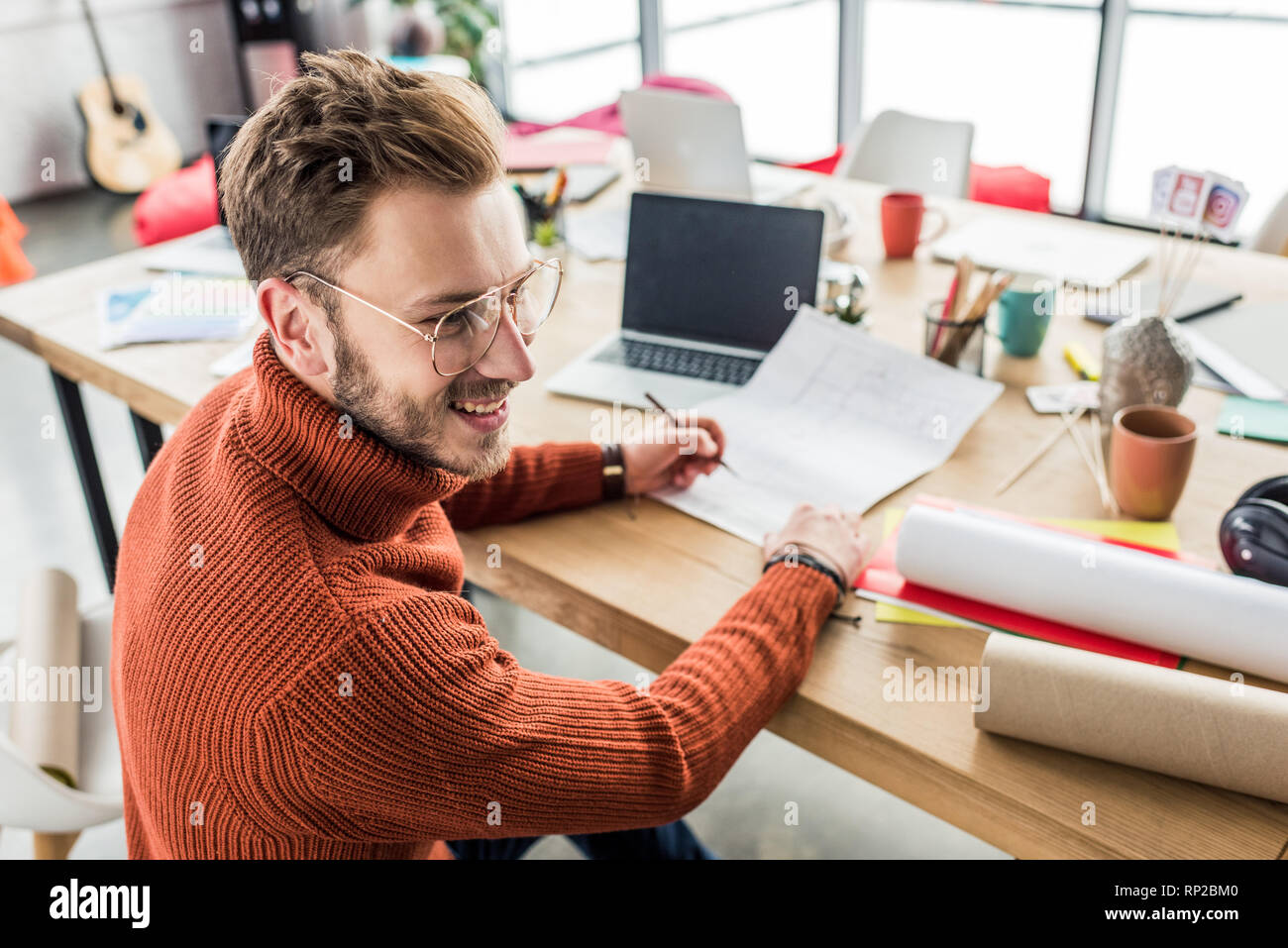 Man working laptop blueprints table hi-res stock photography and images ...