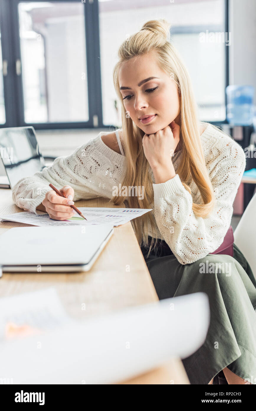 beautiful female architect working on blueprint in loft office Stock ...