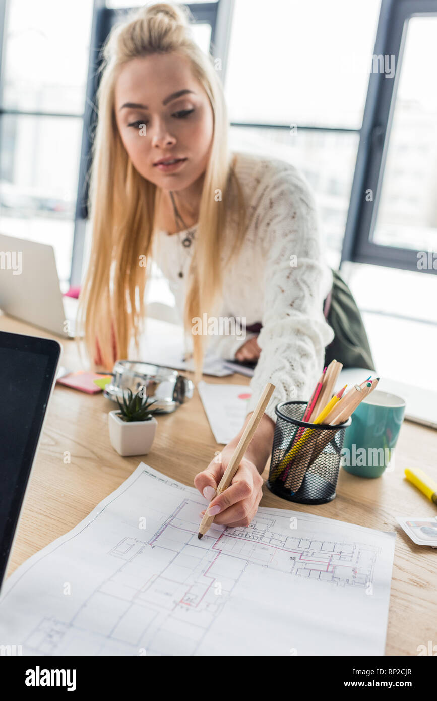 beautiful female architect working on blueprint in loft office Stock ...