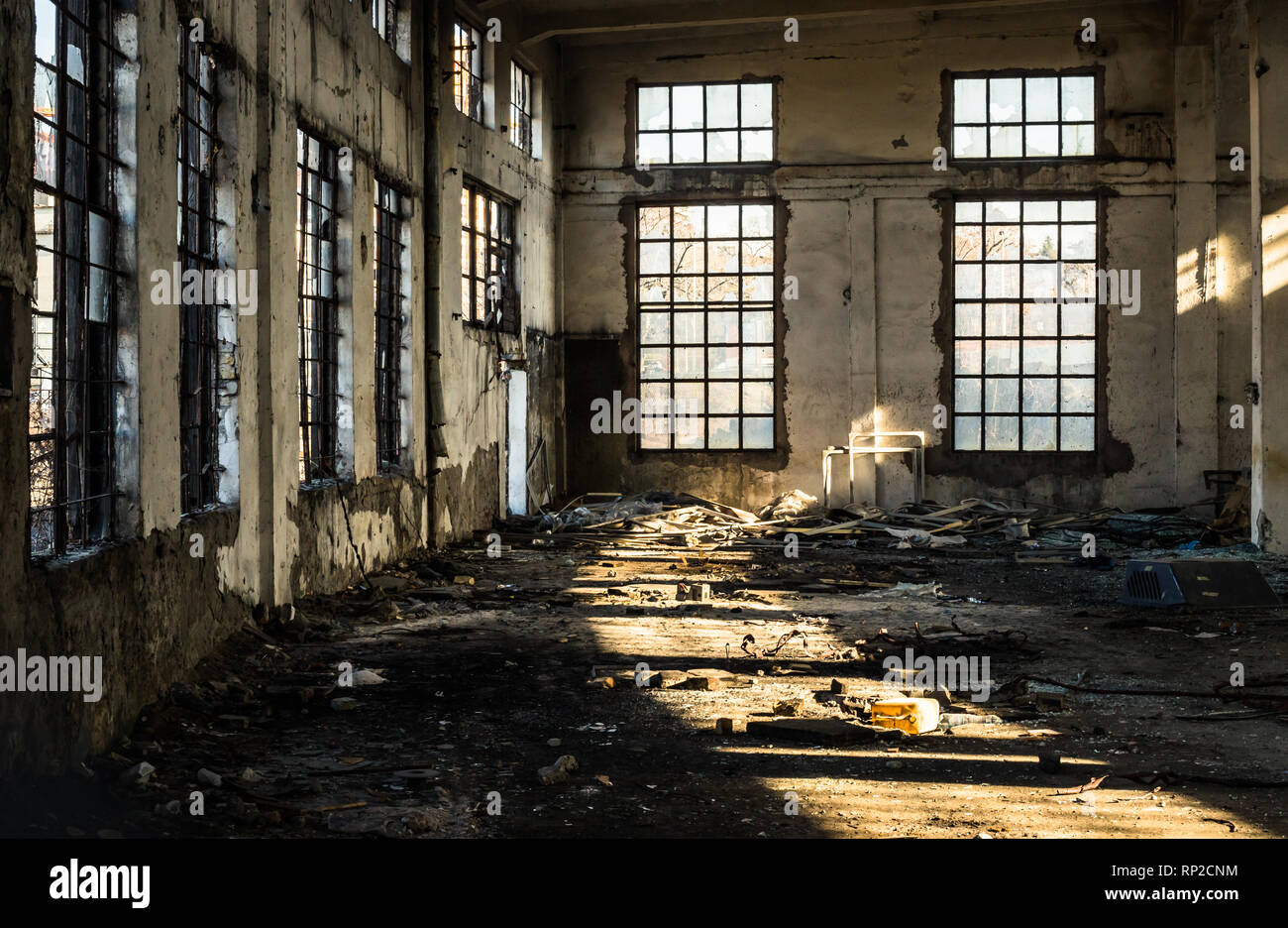 Interior of an old abandoned building lightened through the broken ...