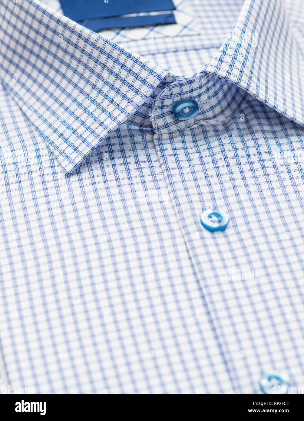 blue shirt with checkered pattern and with a focus on the collar and ...