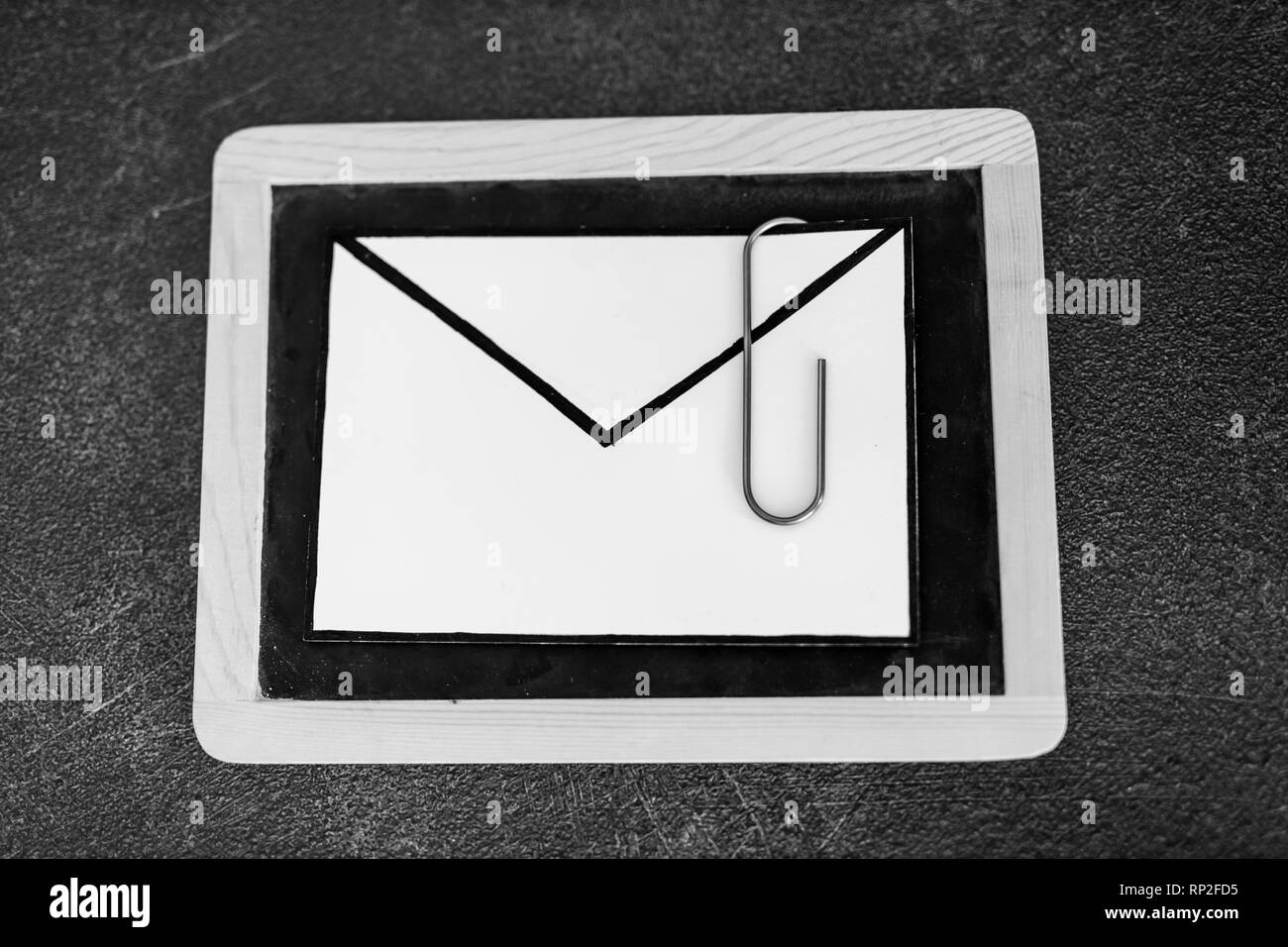 email envelope on blackboard with paper clip symbol of attachment ...