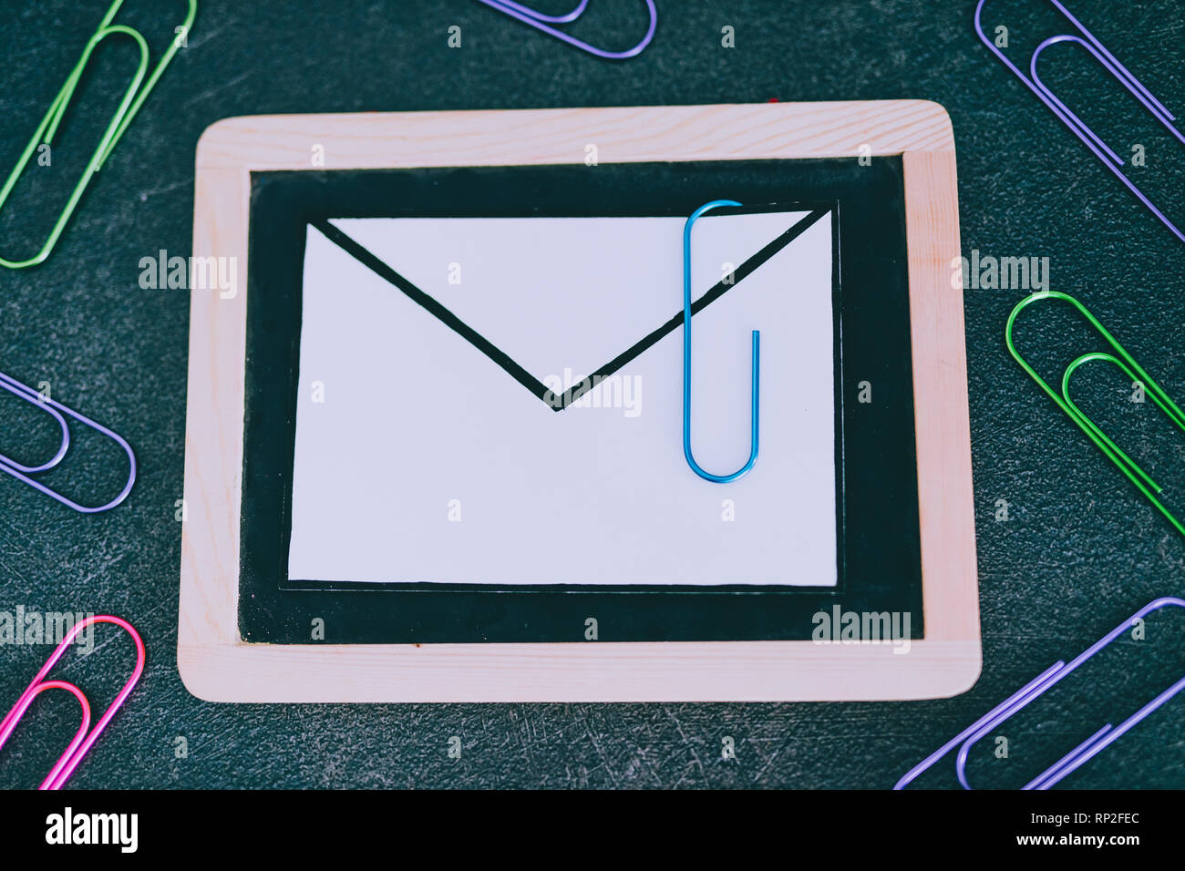 email envelope on blackboard with paper clip symbol of attachment ...