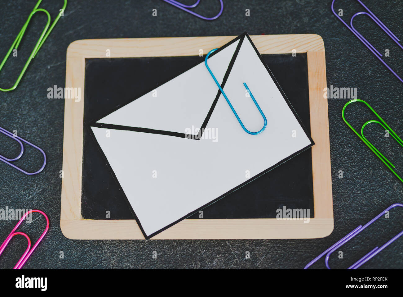 email envelope on blackboard with paper clip symbol of attachment ...