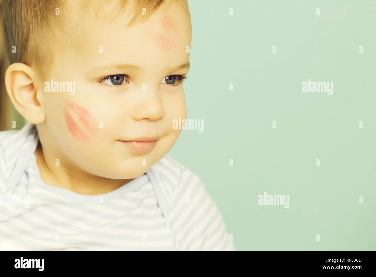 Adorable baby with kiss trace Stock Photo - Alamy