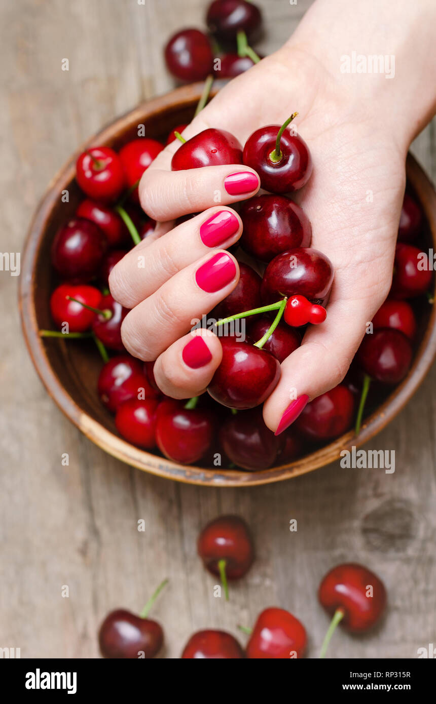 Female hand holding cherries hi-res stock photography and images - Alamy