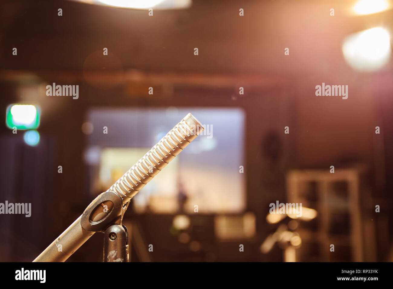 Metal microphone in the studio, studio lights in the blurry background ...
