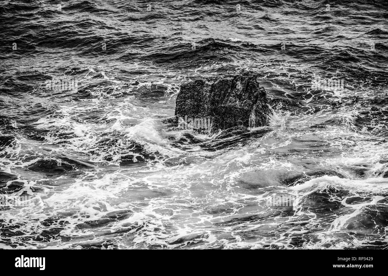 Wild and strong waves hitting against rocks in the ocean Stock Photo ...