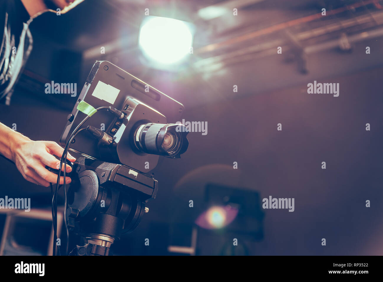 Male cameraman is operating a film camera in a television studio Stock ...