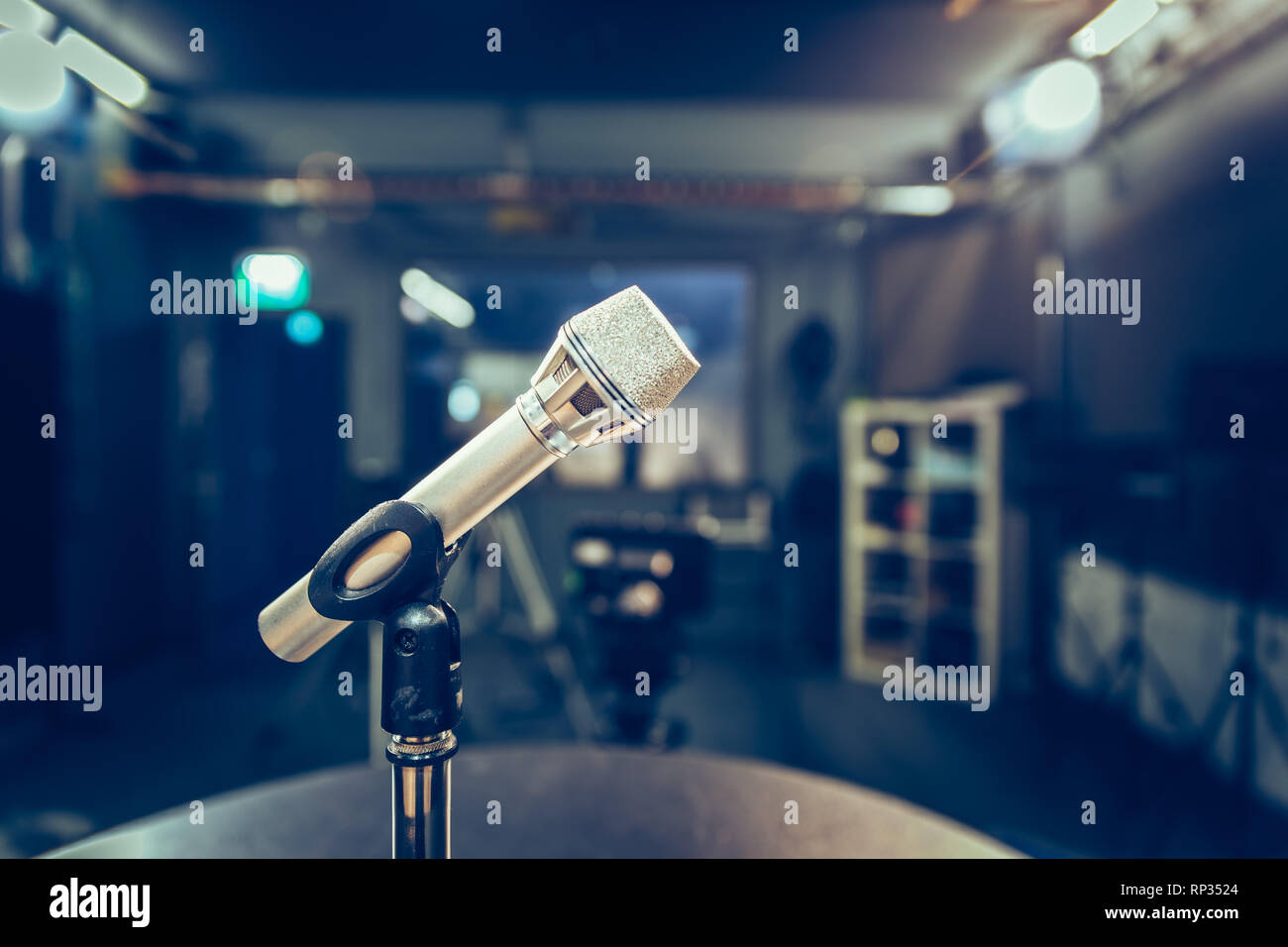 Metal microphone in the studio, studio lights in the blurry background ...