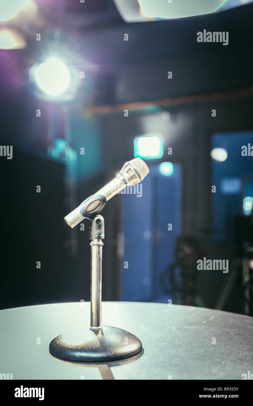 Metal microphone in the studio, studio lights in the blurry background ...