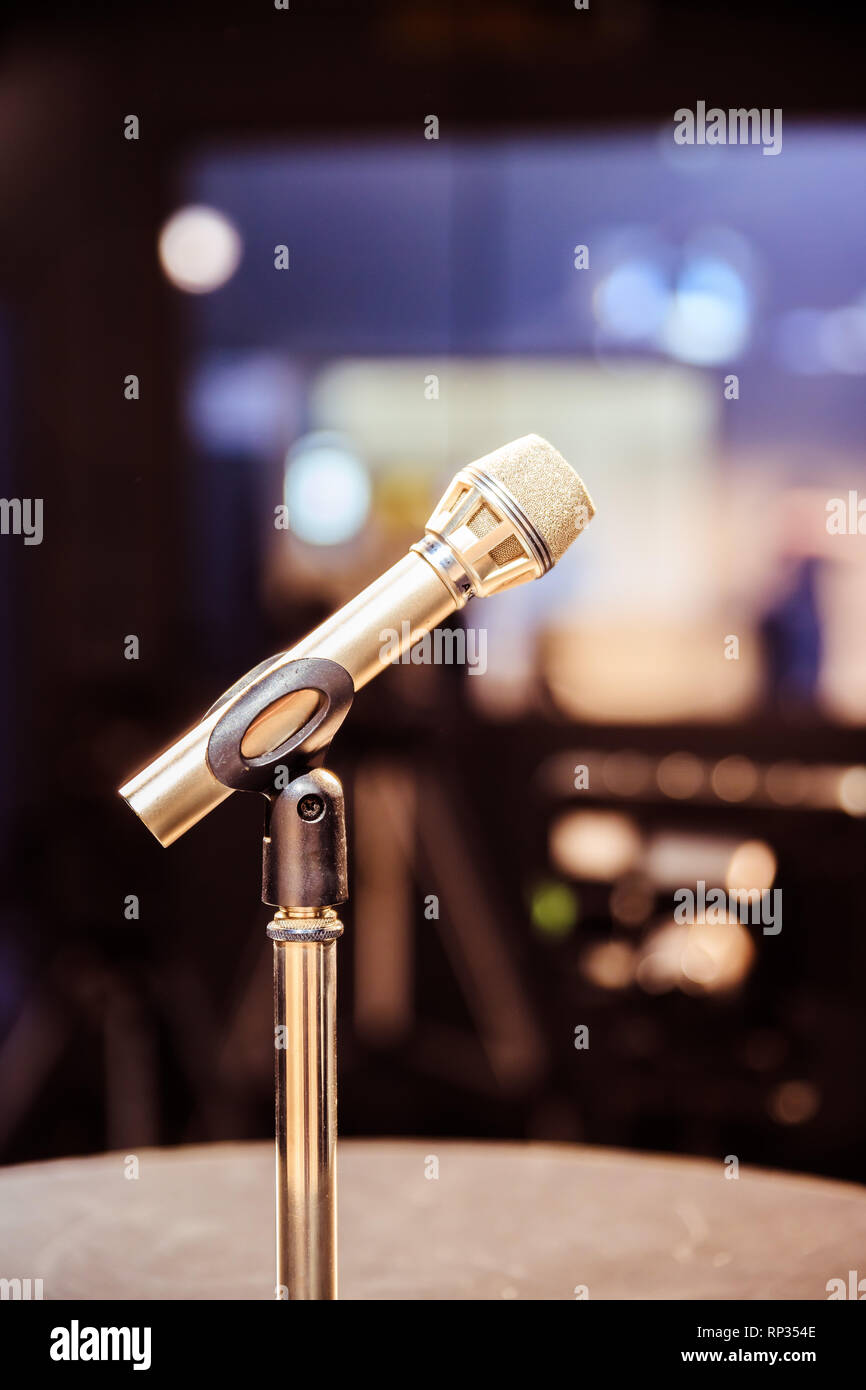 Metal microphone in the studio, studio lights in the blurry background ...