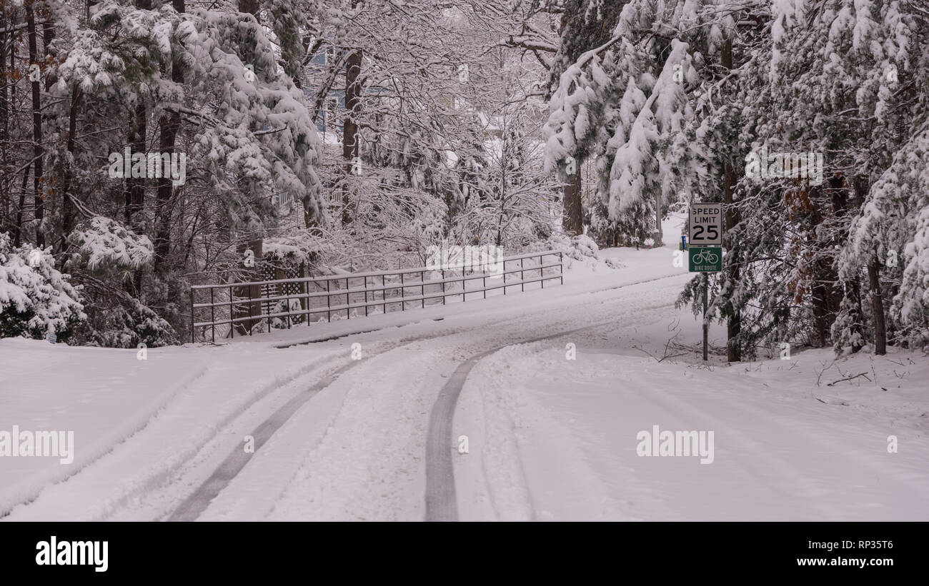snow covered street and fence in residential neighborhood Stock Photo ...