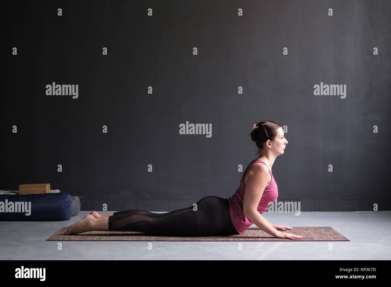 Beautiful sporty fit yogini woman practices yoga asana bhujangasana ...
