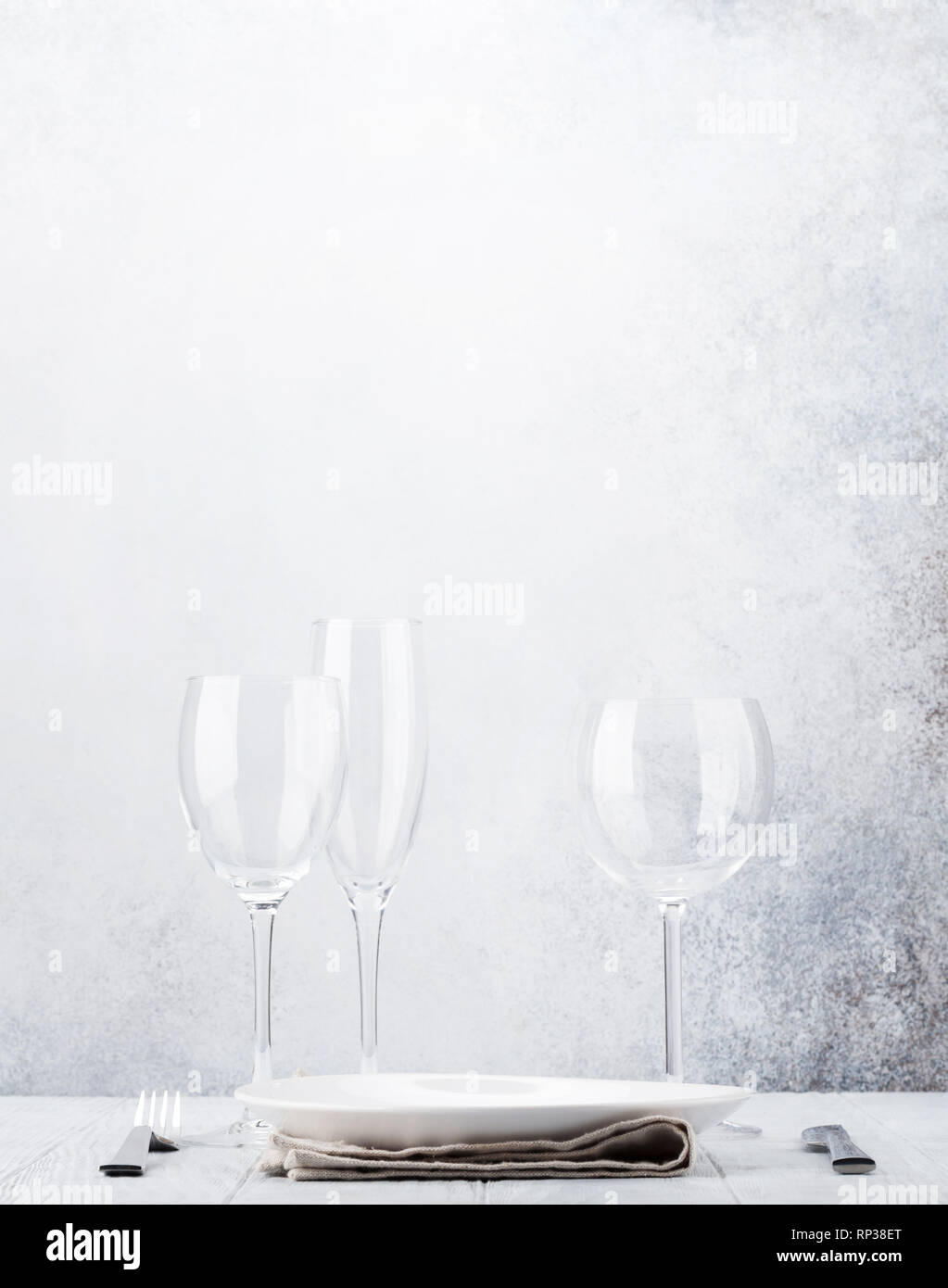 Dinner plate setting with cutlery and glasses. View with copy space ...