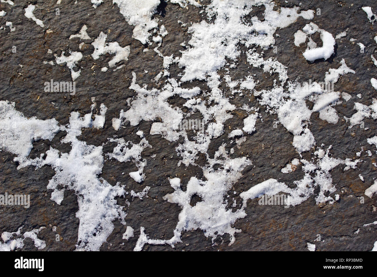 Overhead view macro abstract background of an asphalt road dusted with ...