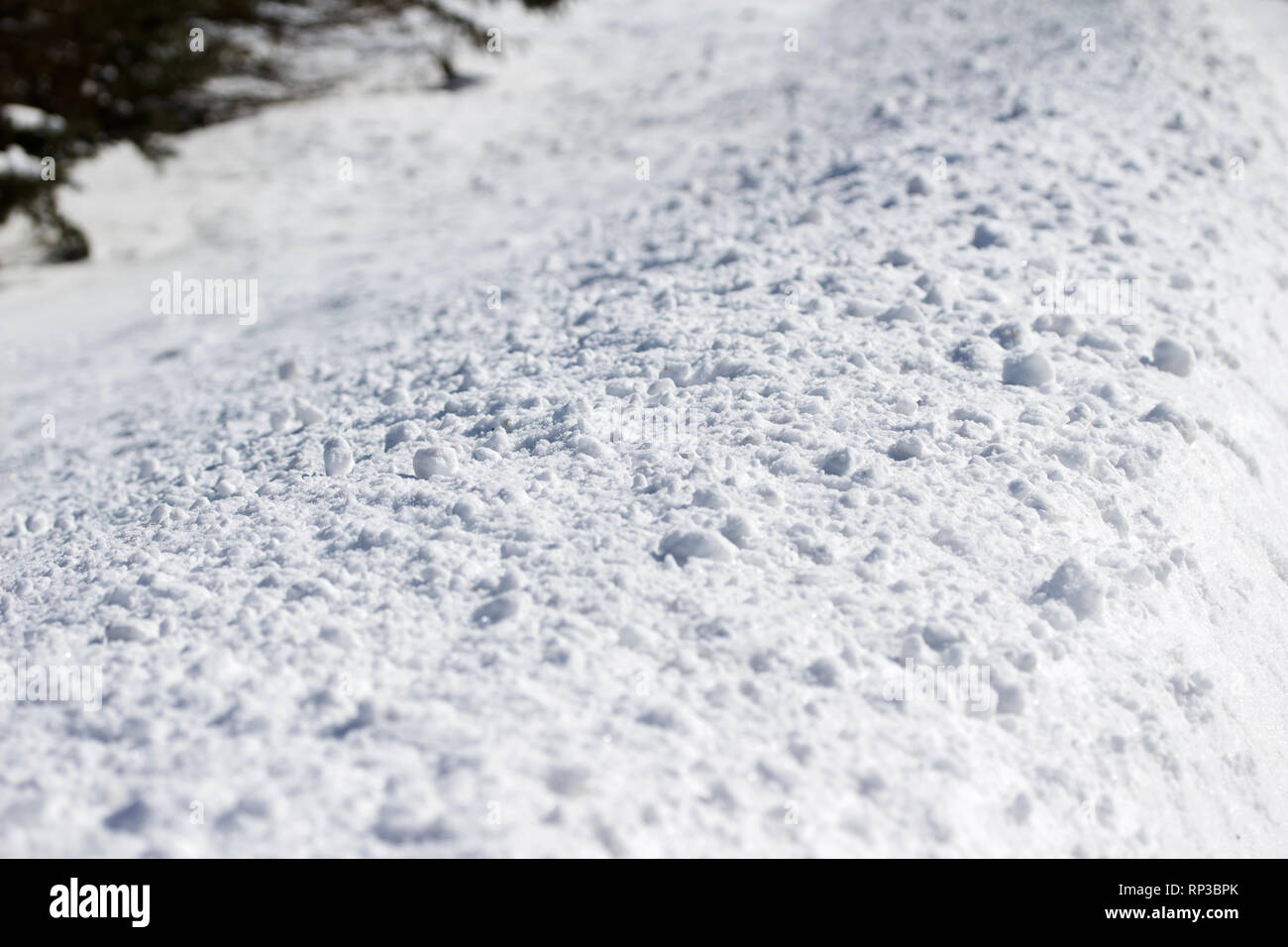 Close up abstract background view of white snow texture on a shoveled ...
