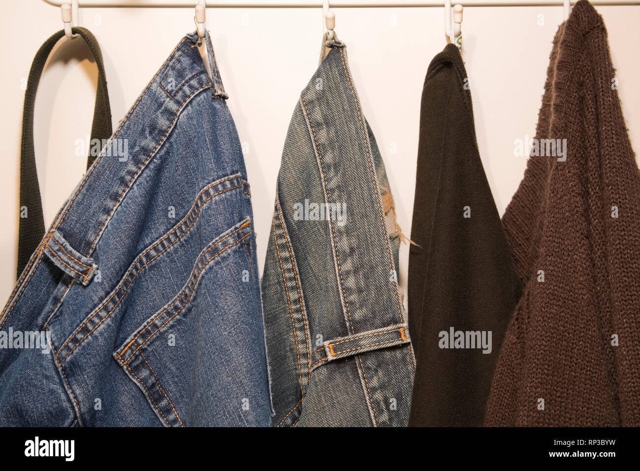 Mens clothes hanging on hooks hi-res stock photography and images - Alamy