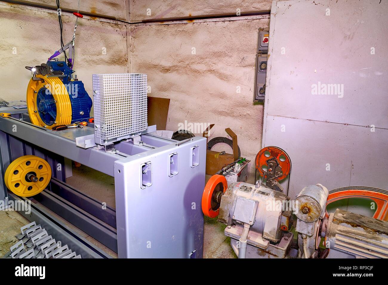 Part of industrial lift. Pulley wheel in engine room. Reconstruction of ...