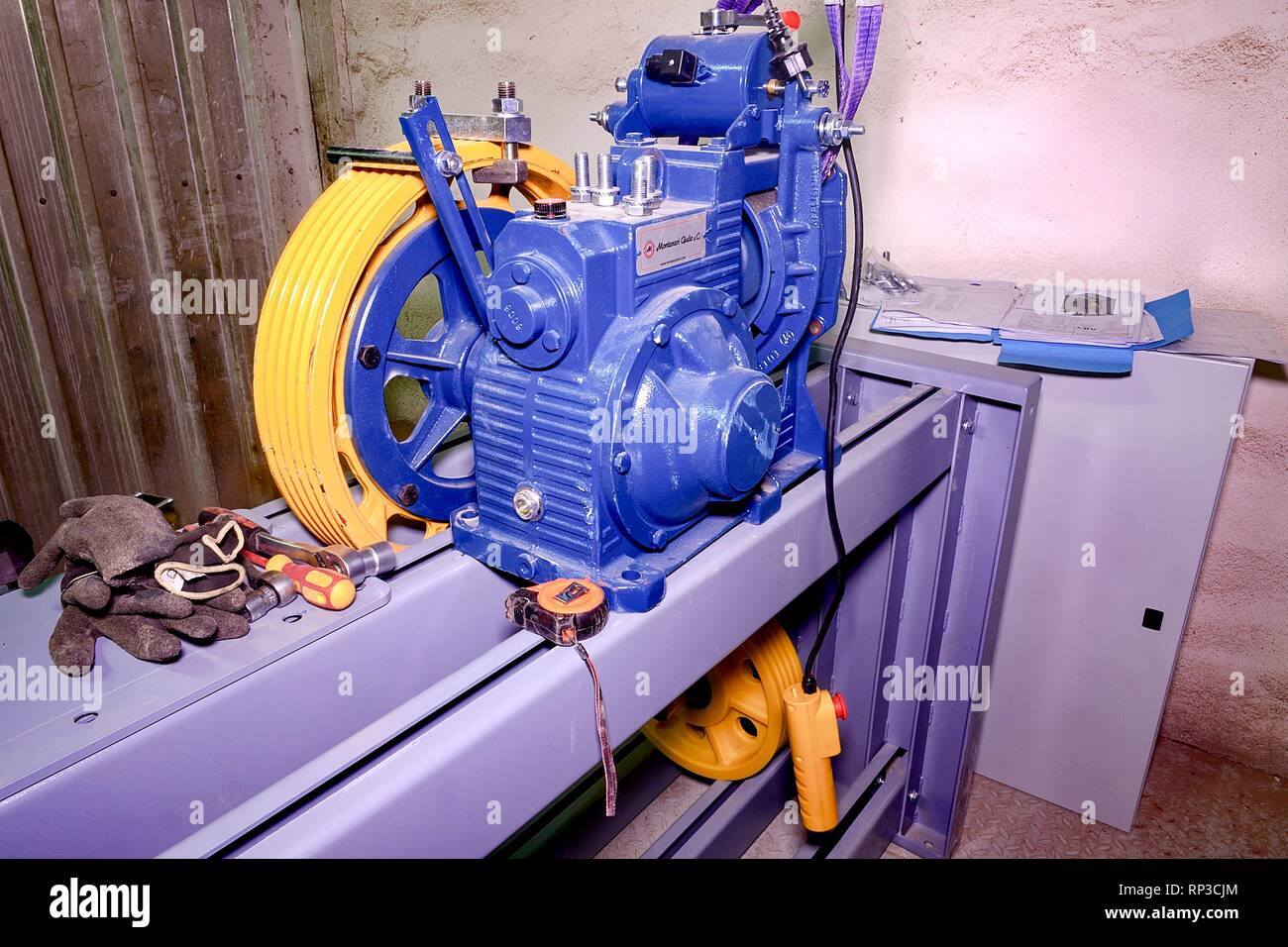 Part of industrial lift. Pulley wheel and engine in engine room ...