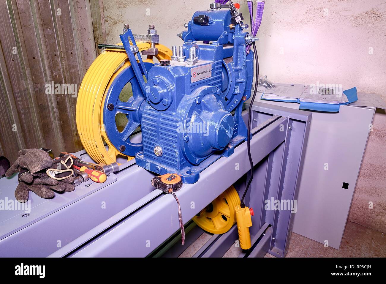 Part of industrial lift. Pulley wheel and engine in engine room ...