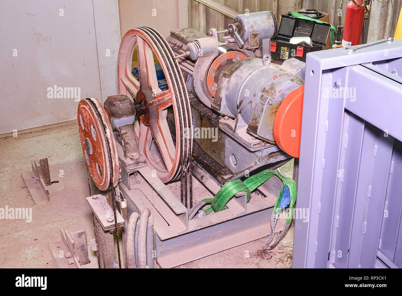 Part of industrial lift. Pulley wheel and engine in engine room ...