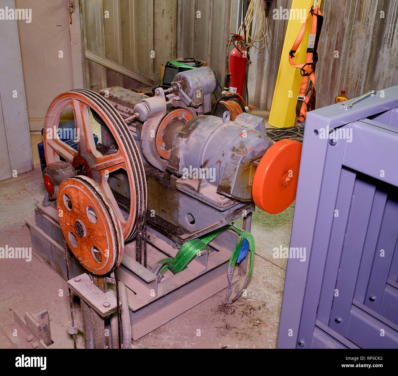 Part of industrial lift. Pulley wheel and engine in engine room ...