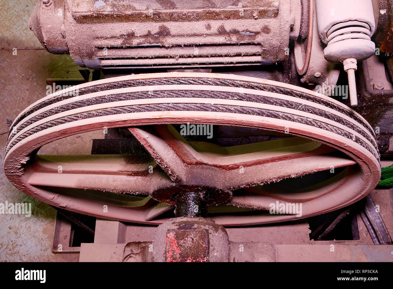 Old pulley wheel and engine in engine room. Closeup Stock Photo - Alamy