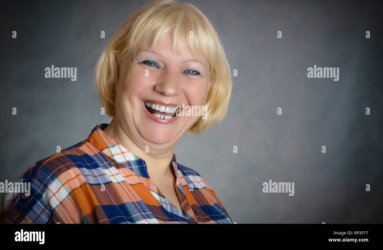 Middle aged woman portrait on dark background. Color toned image Stock ...