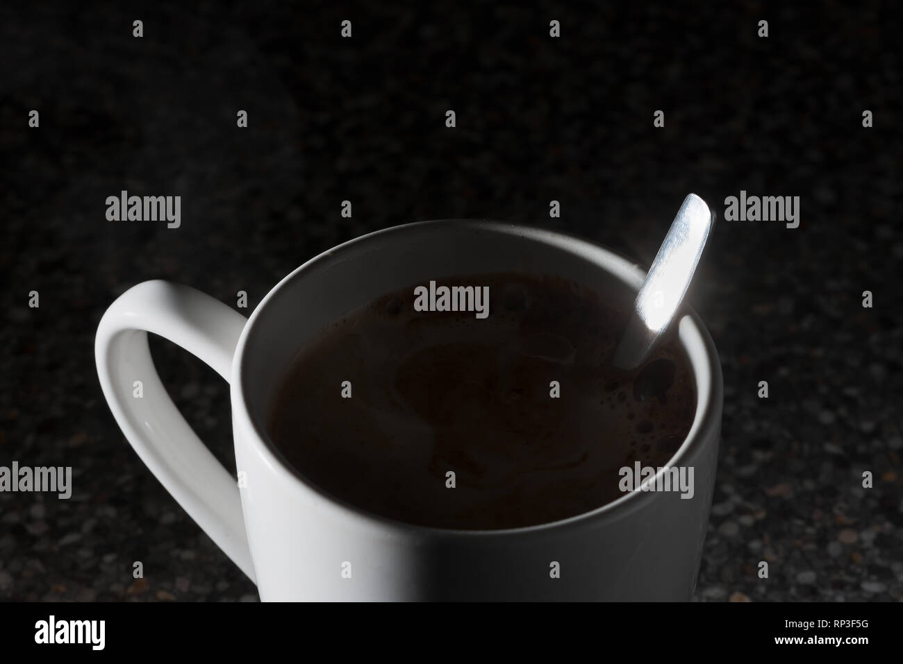 Rim of white coffee cup mug with spoon and handle, apparently making it ...