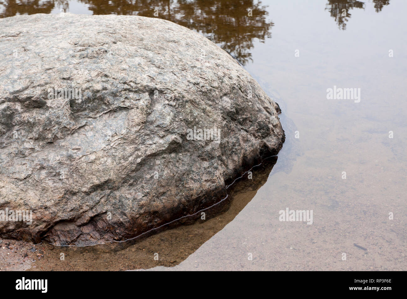 Big stone is in the lake in Finland at summer Stock Photo - Alamy