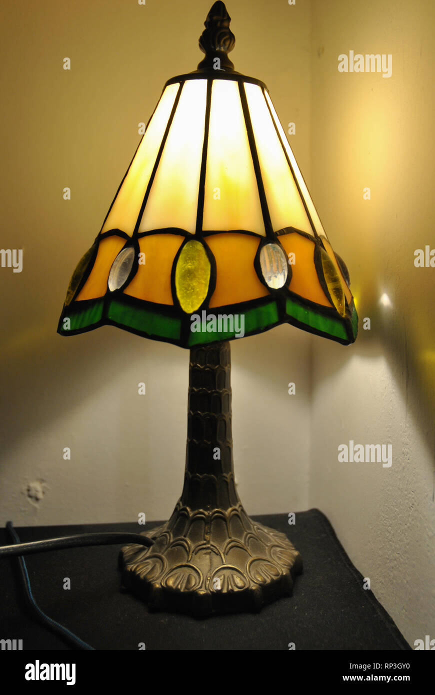 a lamp with a shell and glass shade illuminated Stock Photo - Alamy
