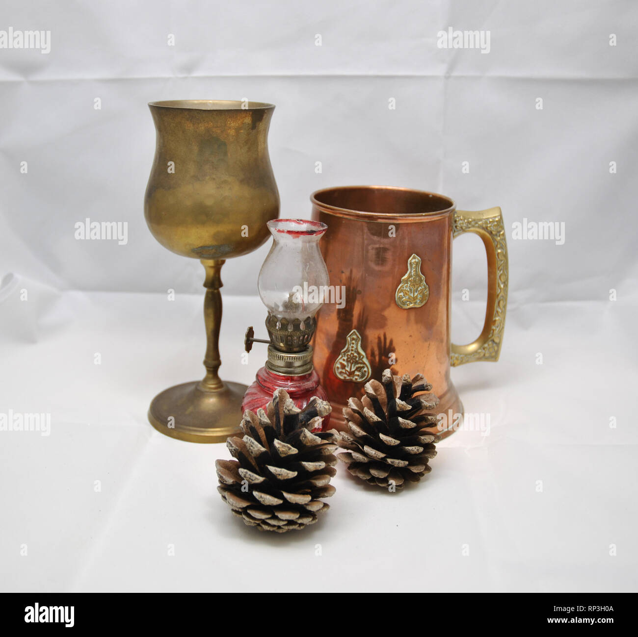 A still life of brass cups, mini lantern and pin cone angle 2 Stock ...