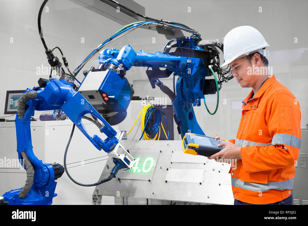 Engineer programming control laser robotic cutting on metal plate ...