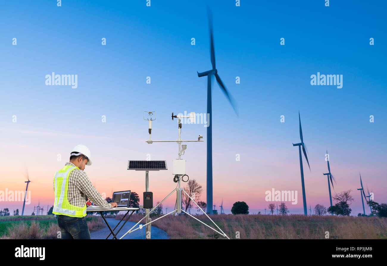 Engineer using laptop computer collect data with meteorological ...