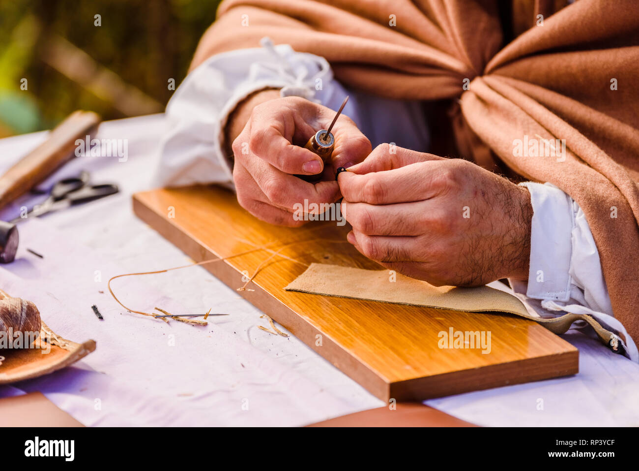 Artisans disguised in medieval times showing old crafts in a festival ...