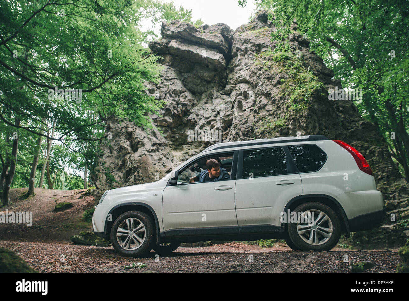 man driving suv car in forest. off road. lifestyle concept Stock Photo ...